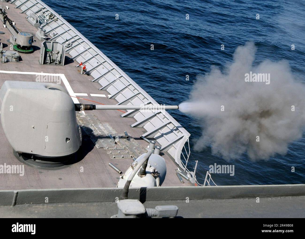 US Navy A cloud of propellant-gas discharge is expelled from the 5-inch ...