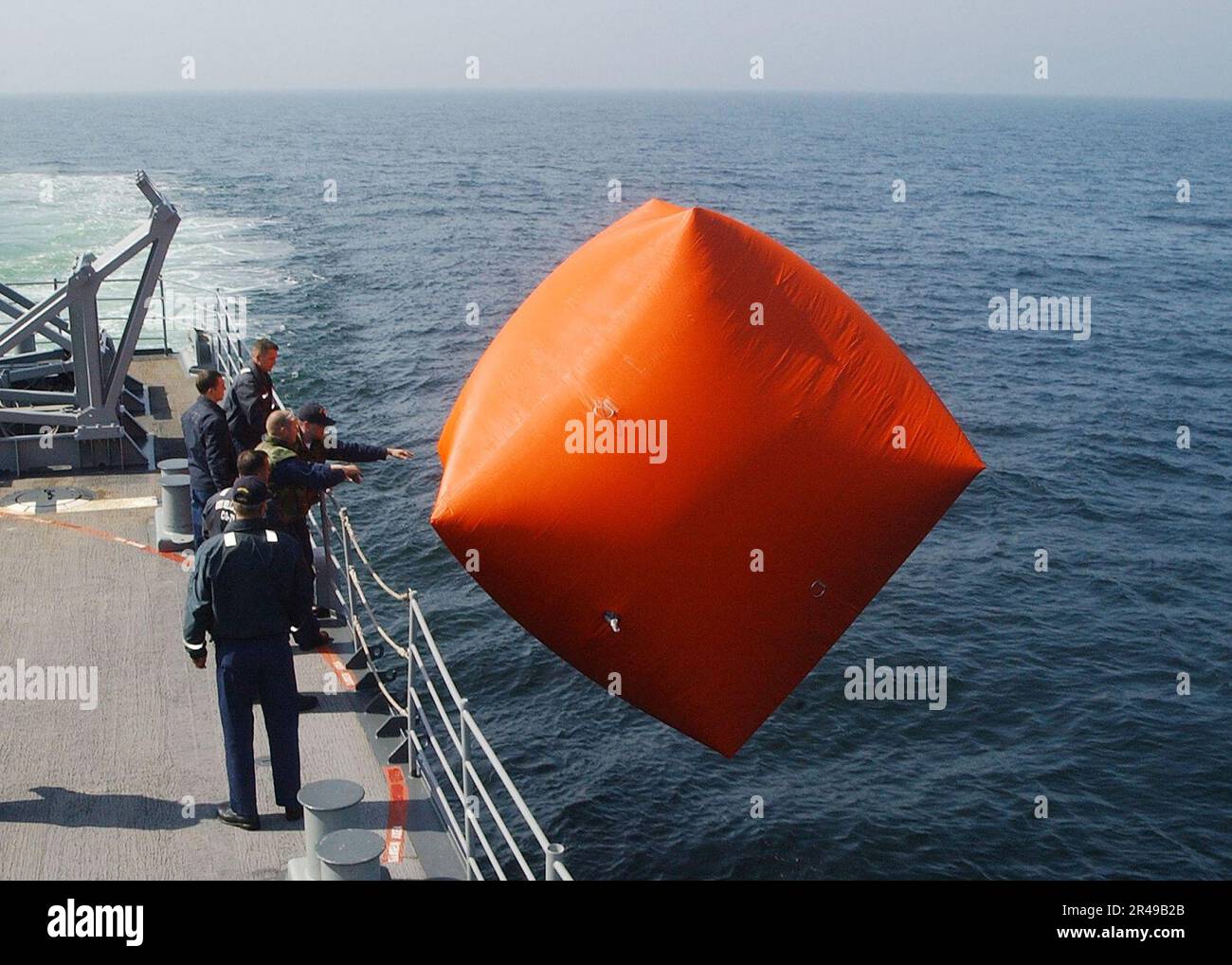 US Navy Sailors launch a killer tomato prior to executing a small arms ...