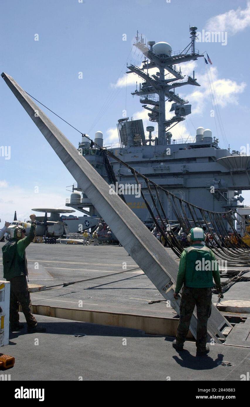 US Navy Flight deck personnel raise the support stanchions to position ...