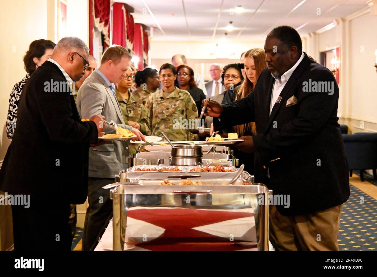 Guest speaker Don Coleman and close friend preparing their plates at ...