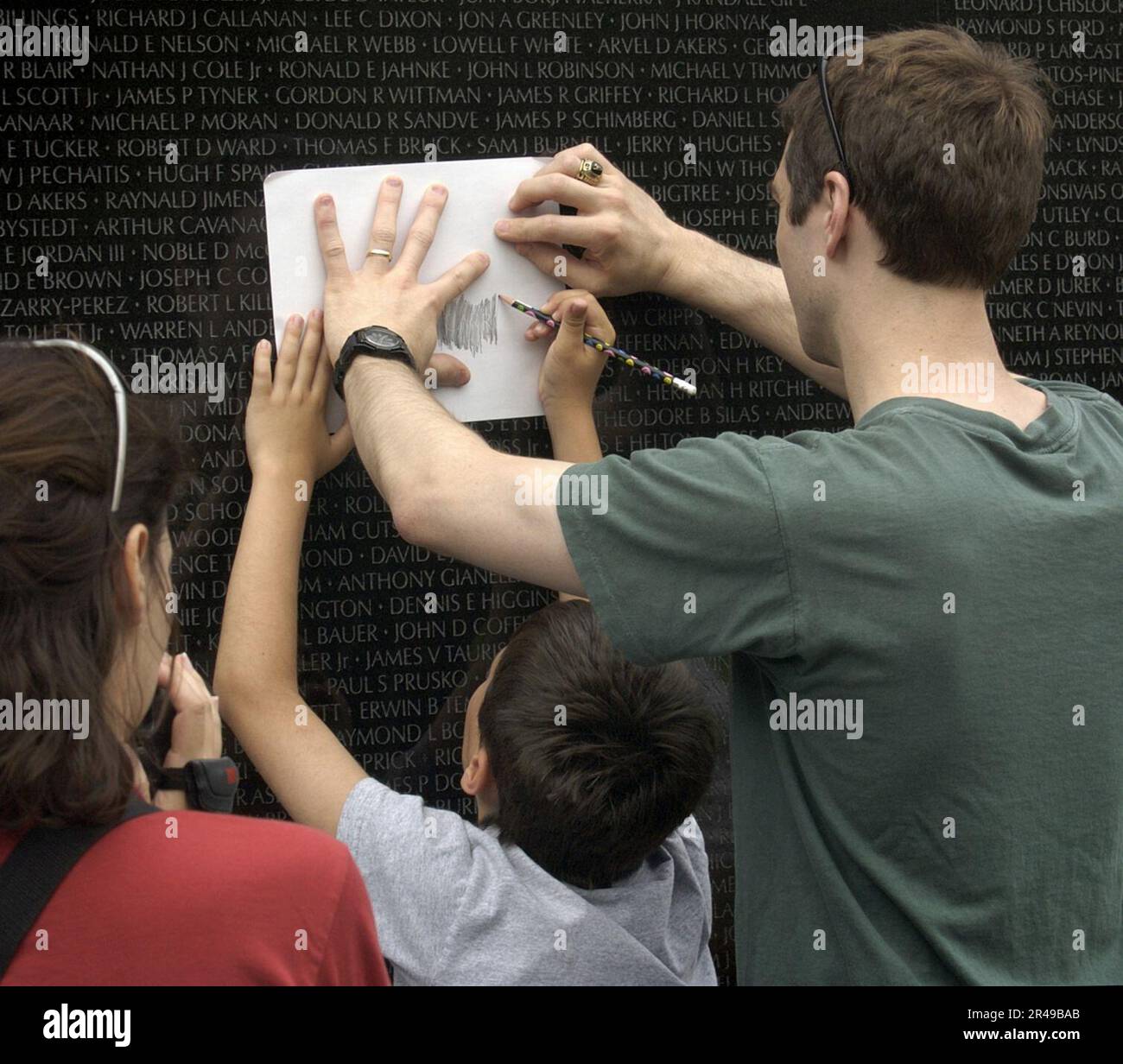US Navy Visitors to the Vietnam Veterans Memorial Wall, take rubbings ...