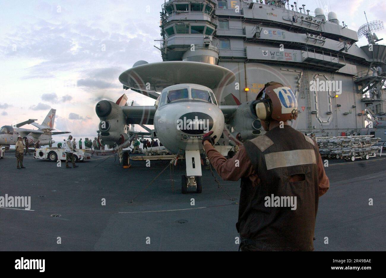 US Navy A plane captain signals the pilot during an engine start-up of ...