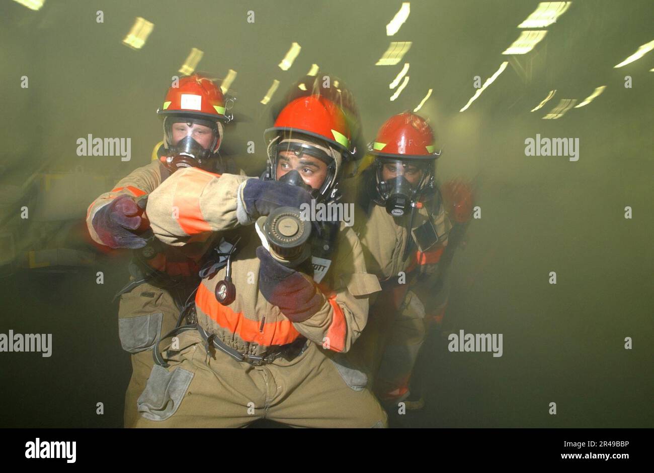 US Navy A damage control fire team battles a simulated fire Stock Photo ...