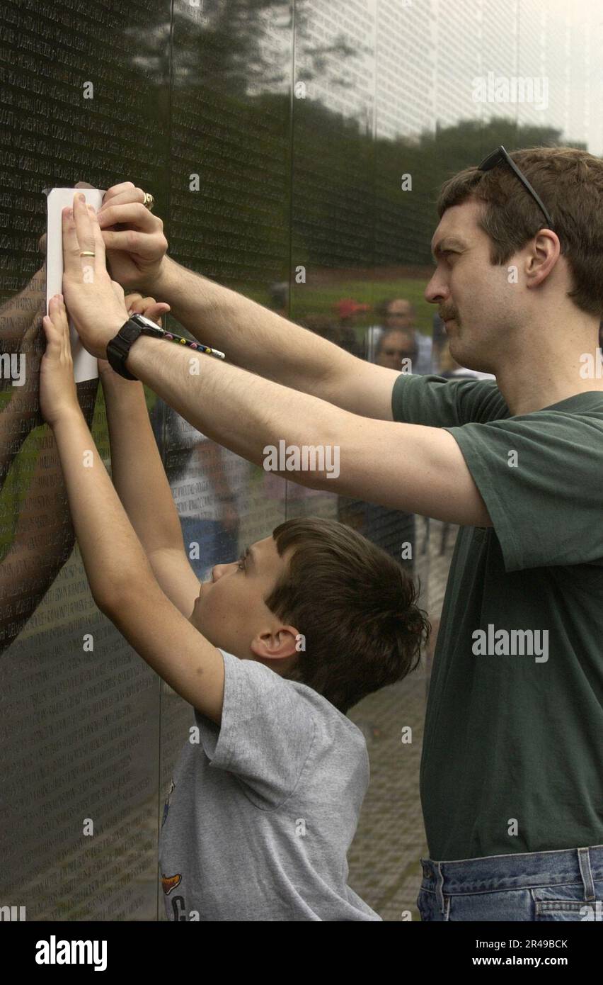 US Navy Visitors to the Vietnam Veterans Memorial Wall, take rubbings ...