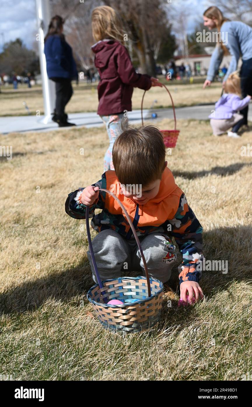 A young child grabs a candy filled egg during the Kingsley Field egg ...