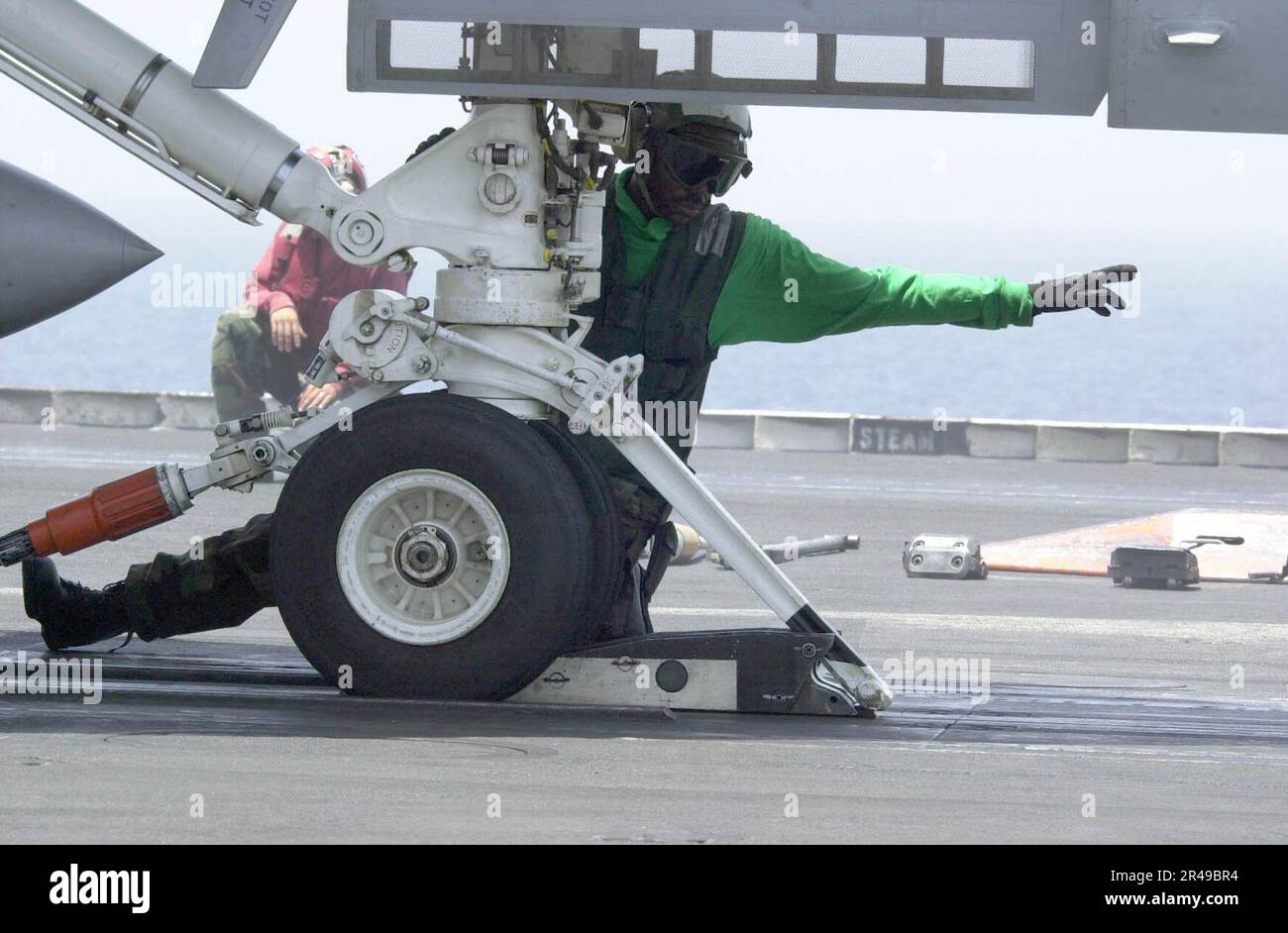 US Navy A Nimitz crewmember prepares an F-A-18 Hornet for launch on one ...