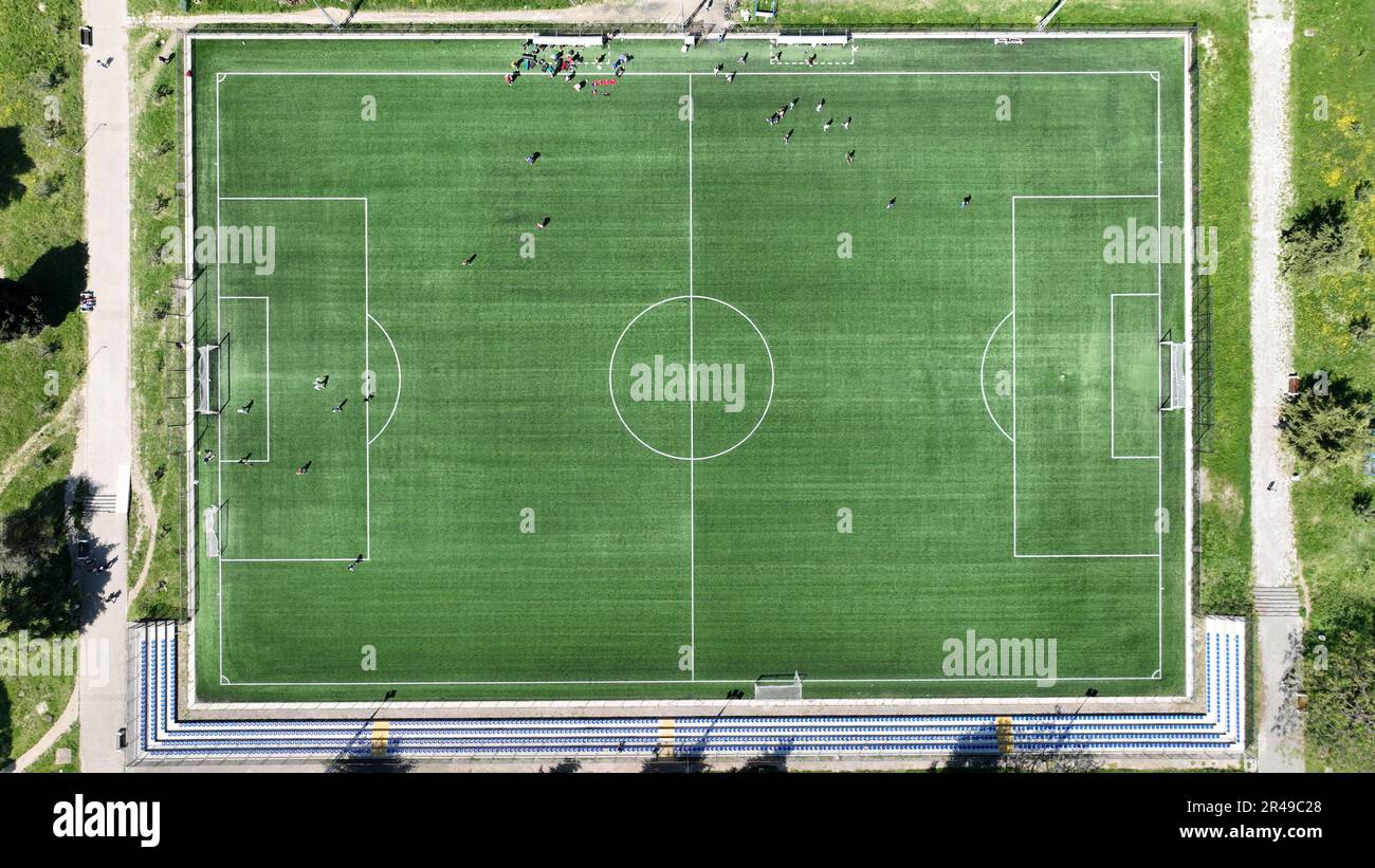 An aerial view of a soccer field in a lush, green forest environment ...