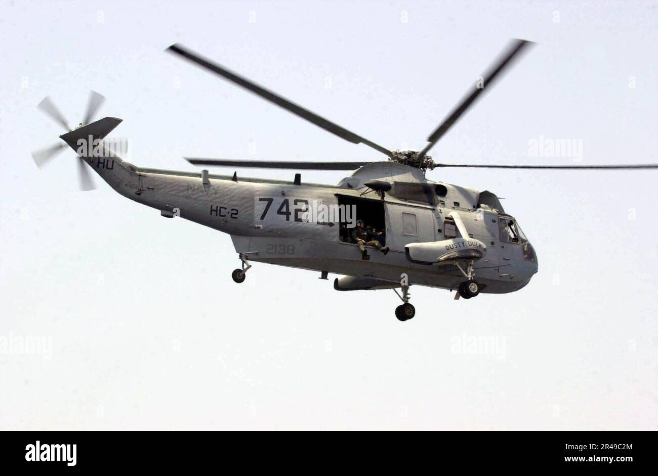 US Navy A UH-3 Sea King helicopter hovers over the flight deck, aboard ...