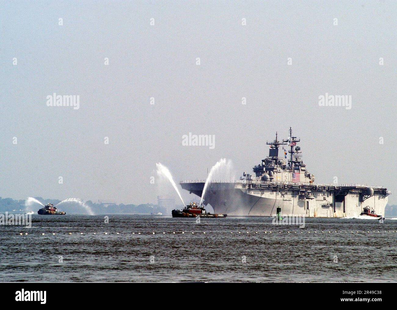 US Navy Sailors and Marines man the rails aboard the amphibious assault ...