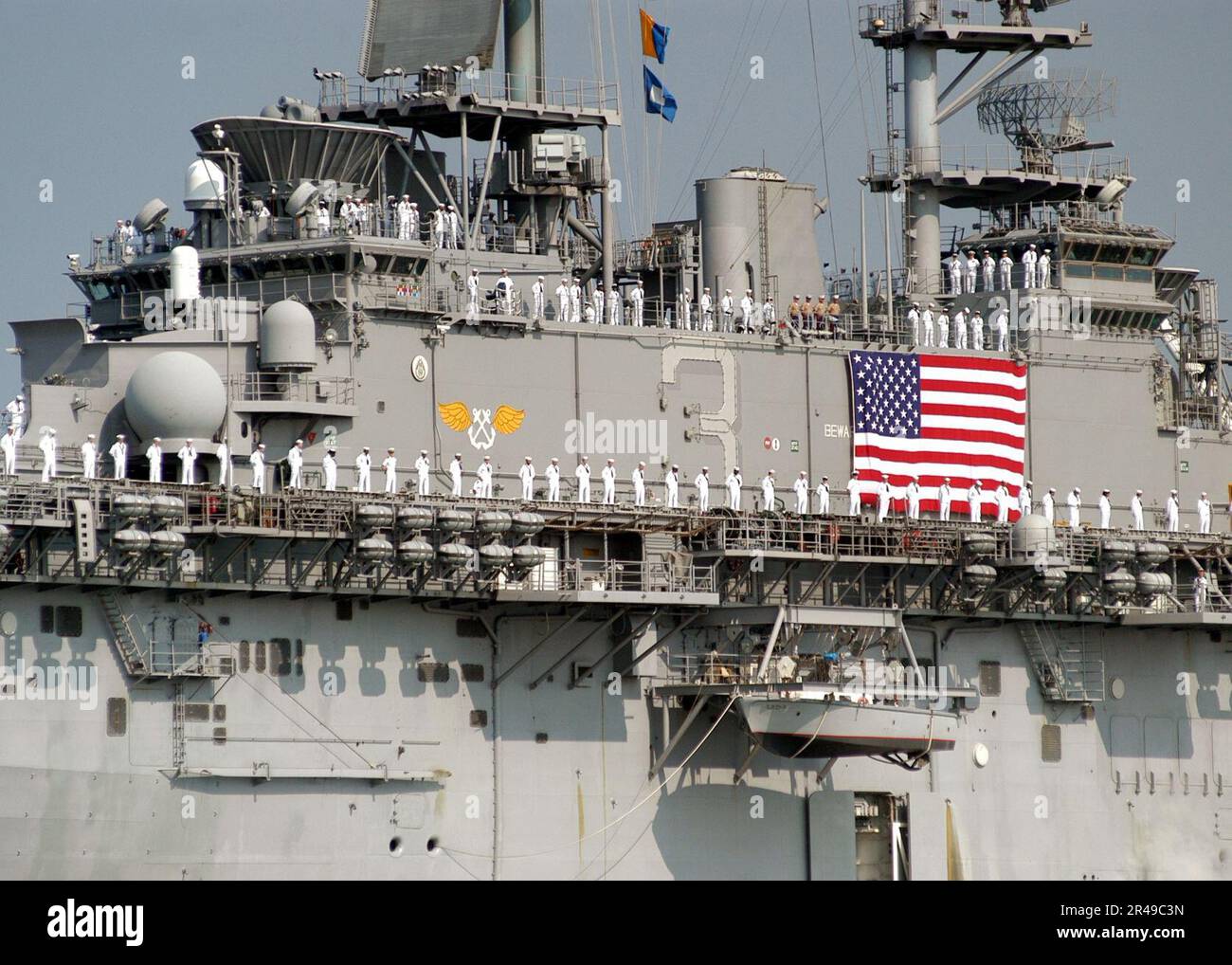 US Navy Sailors aboard USS Kearsarge (LHD-3) man the rails as the ship ...