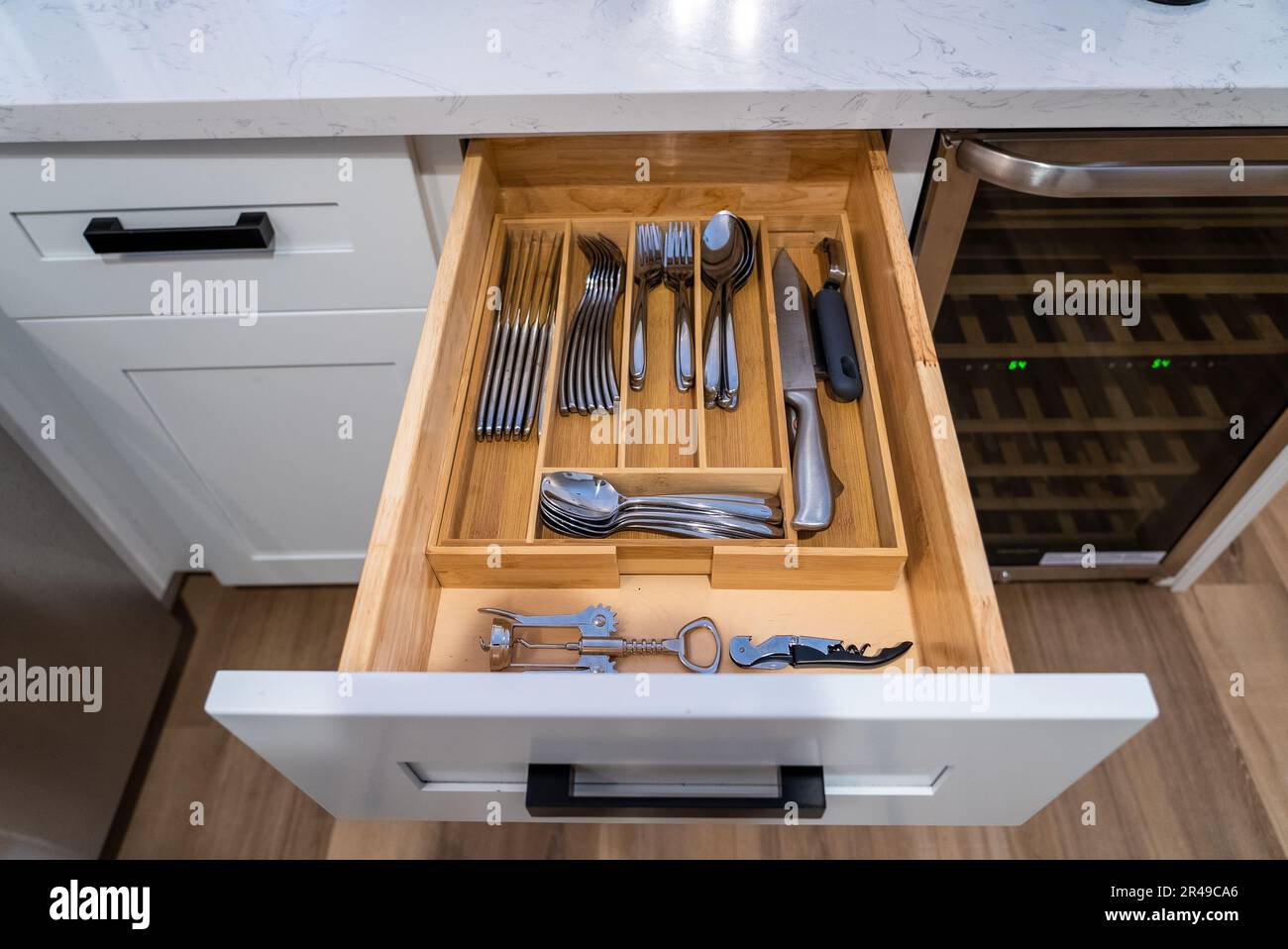 A wooden drawer containing various types of kitchen utensils Stock ...