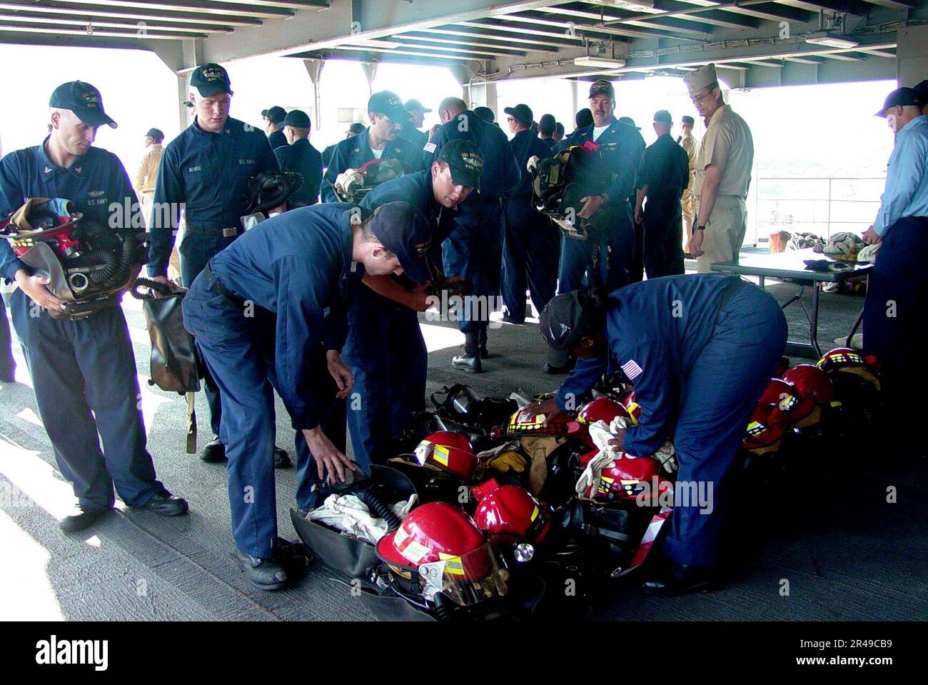 US Navy Crewmembers aboard the submarine tender USS Emory S. Land (AS ...