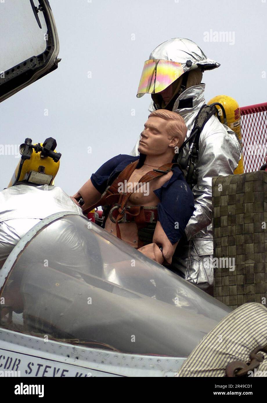 US Navy Crash and salvage personnel pull a simulated injured pilot out ...
