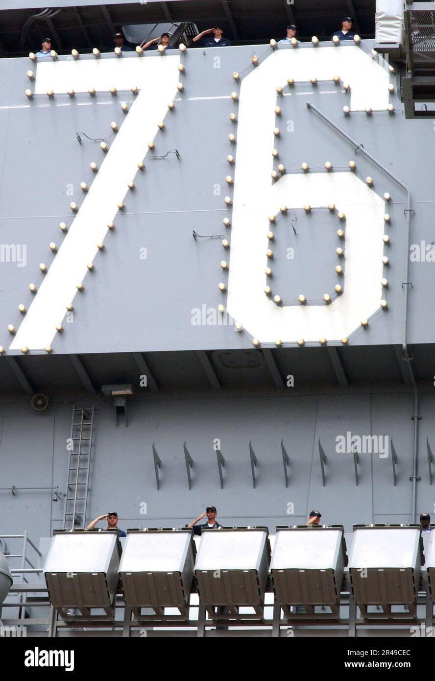 US Navy Sailors man the rails and salute the audience during rehearsals ...