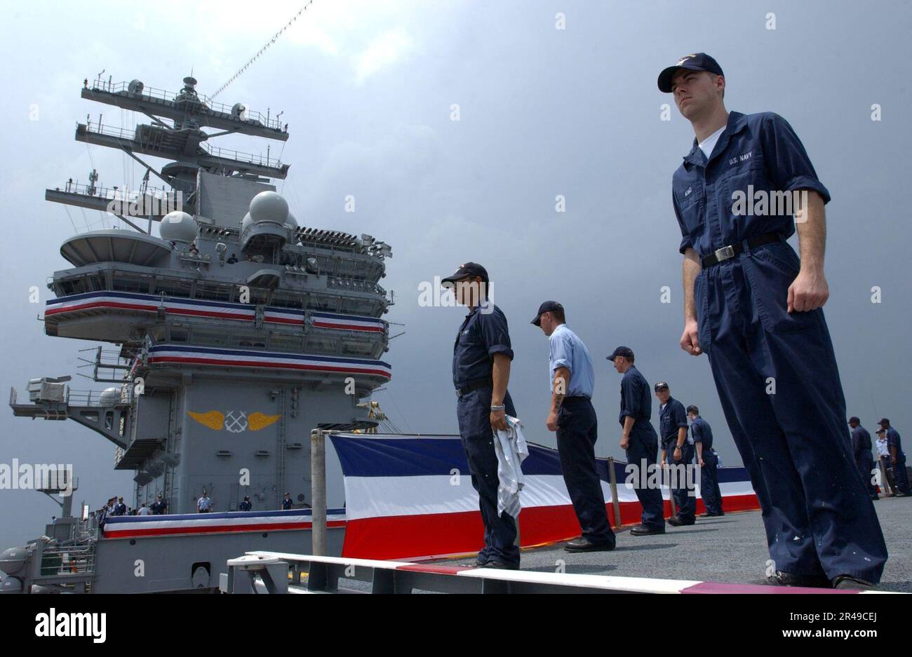 US Navy Sailors rehearse manning-the-rails, on the flight deck, in ...