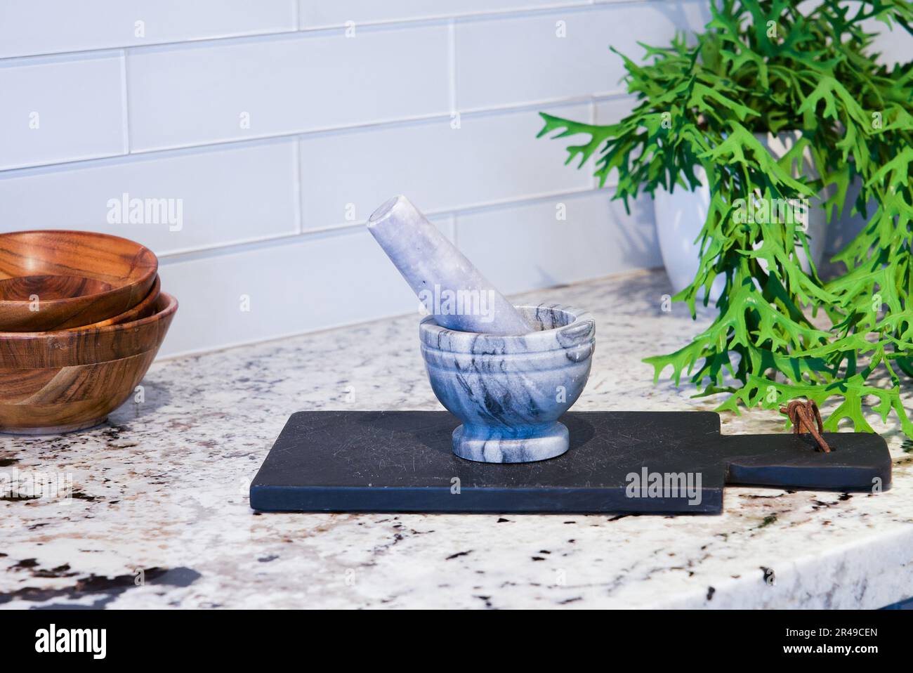 A white marble mortar and pestle set, ideal for crushing and grinding ...