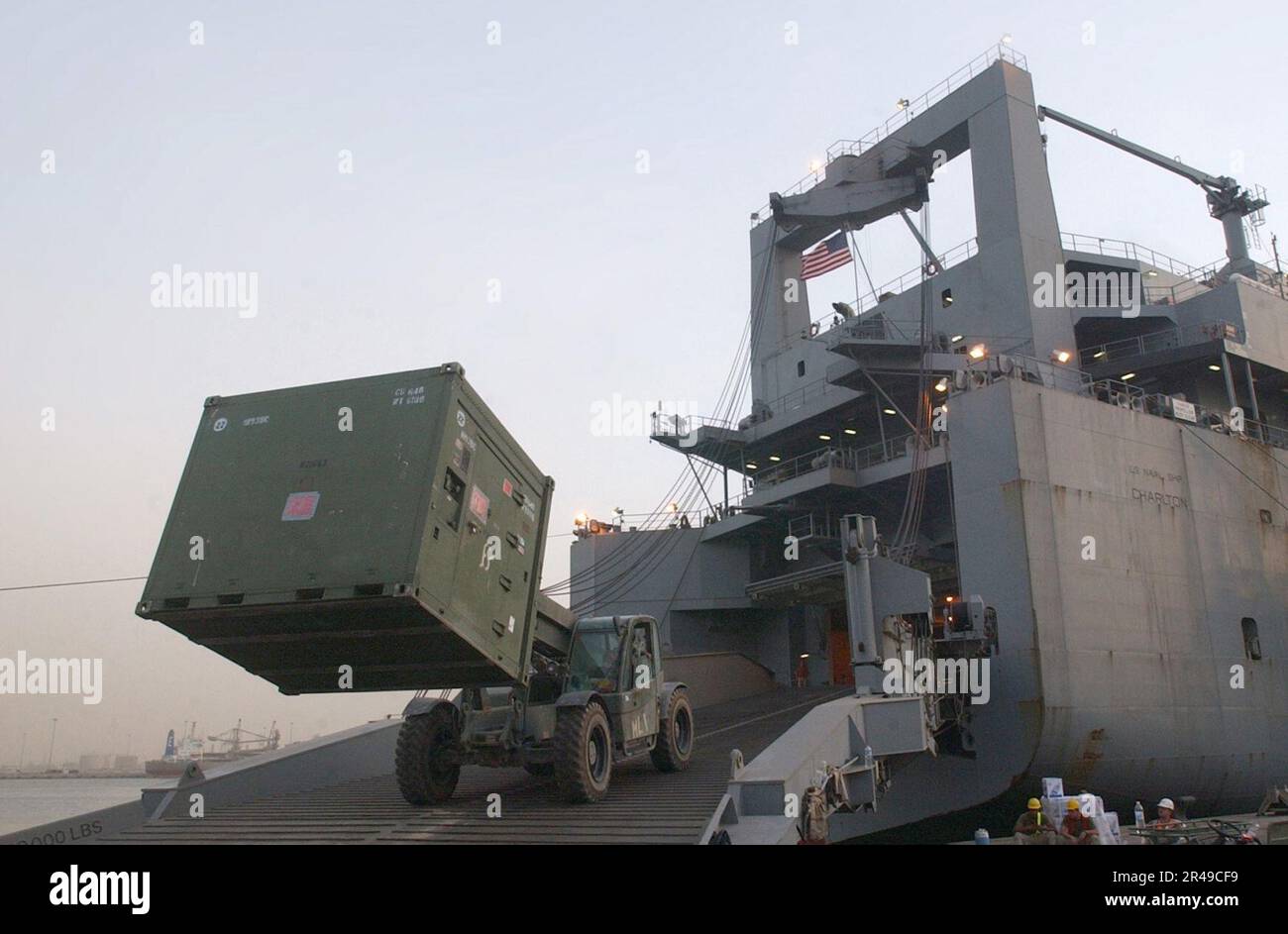US Navy U.S Marine tractor lifts a shipping container Stock Photo - Alamy