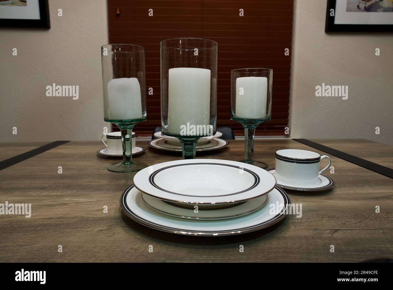 An elegantly set dining table with white plates and dishes Stock Photo ...