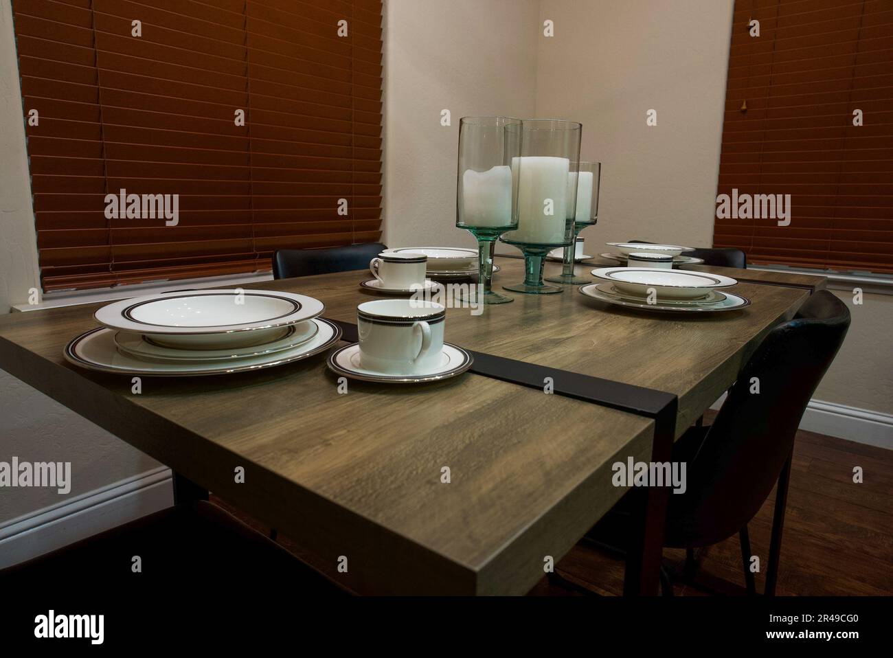 An elegantly set dining table with white plates and dishes Stock Photo ...