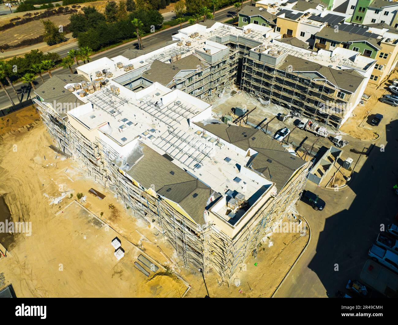 An aerial view of a large building under construction, showing multiple ...