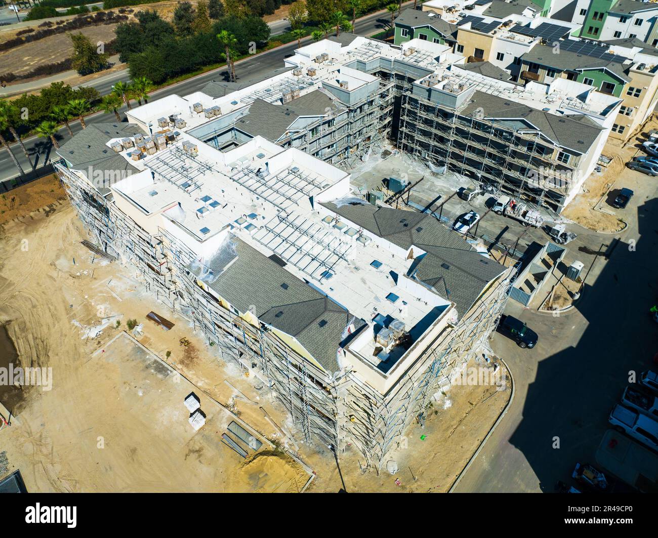 An expansive building undergoing construction with scaffolding covering ...
