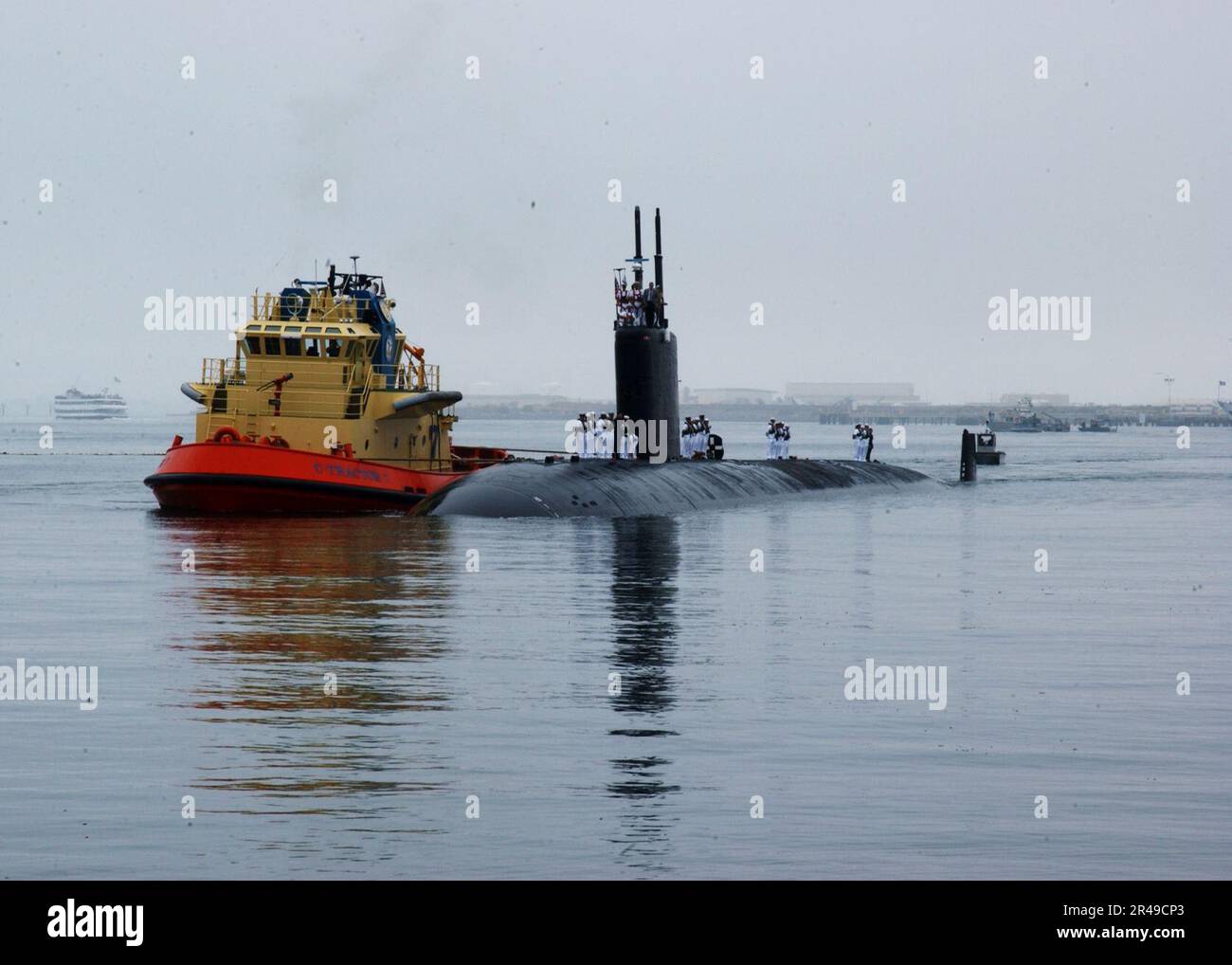 US Navy Assisted by a tugboat, USS Asheville (SSN 758) pulls into her ...