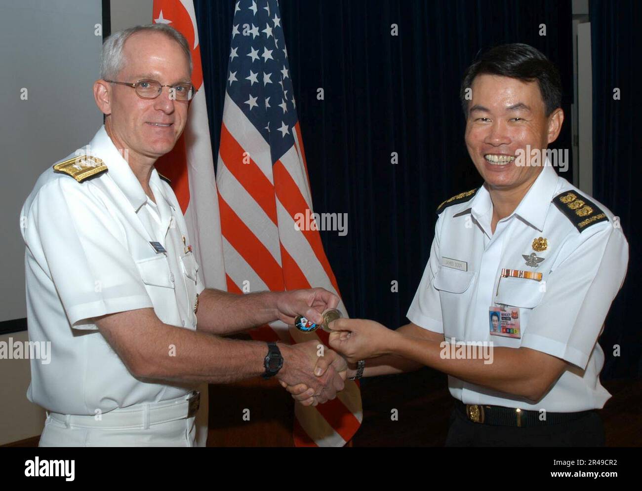 US Navy Rear Adm. Jeff Cassias trades command coins with Col. James ...