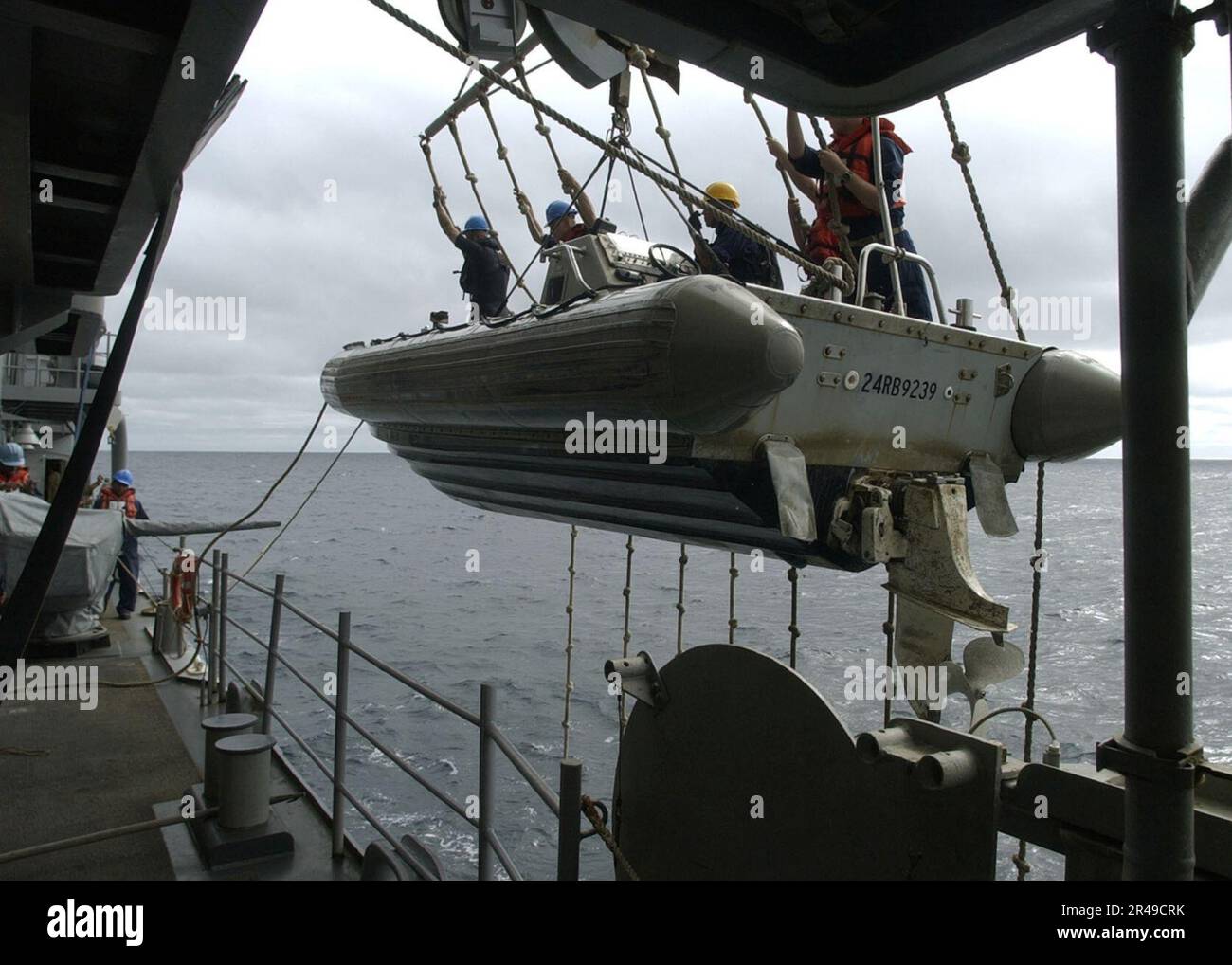 US Navy A rigid hull inflatable boat (RHIB) is brought aboard the ...
