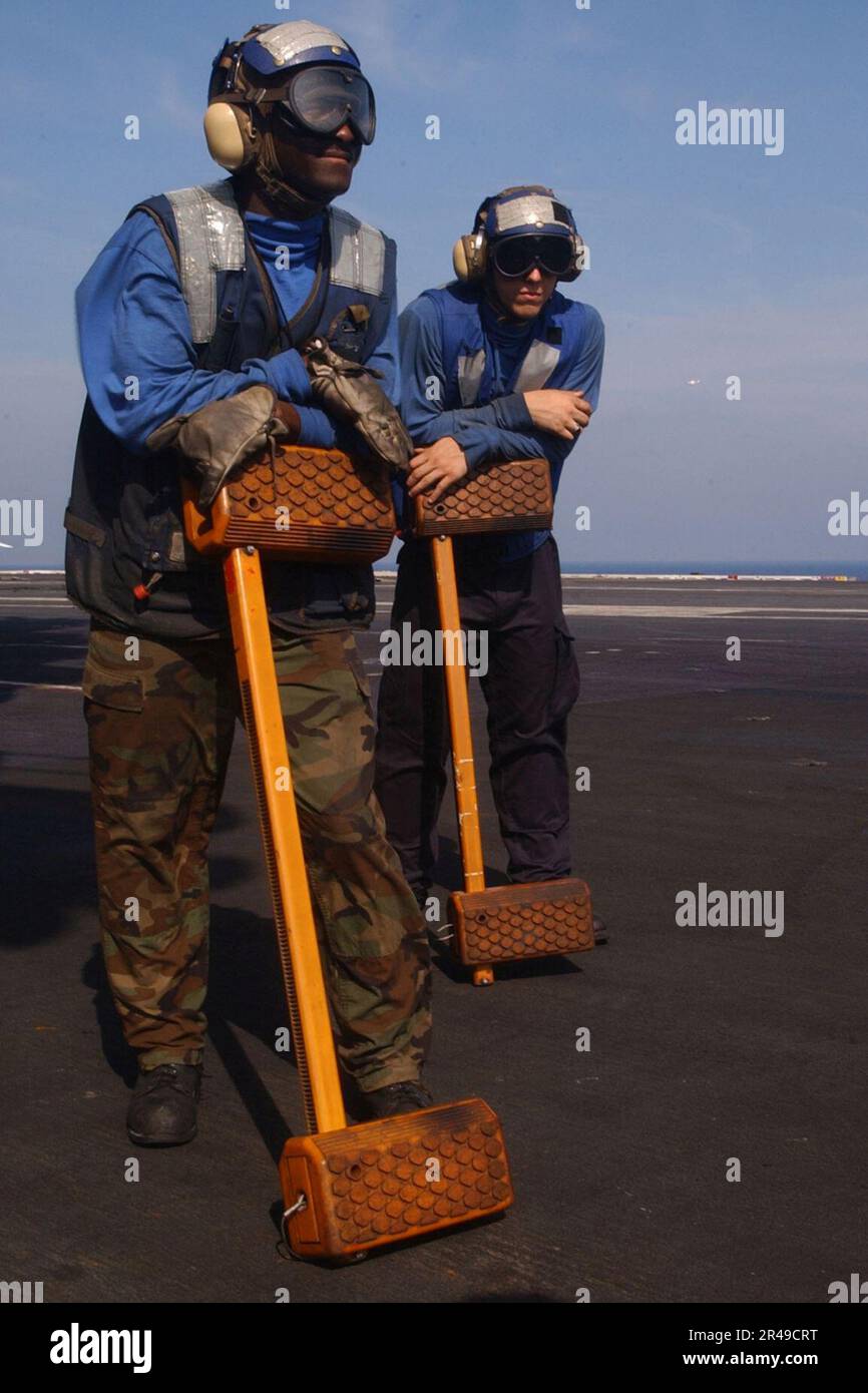 US Navy Airmen Austin Sanders and Daniel Moore stand by awaiting a T-2C ...