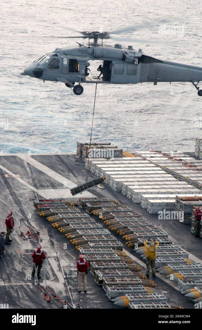 US Navy An MH-60S Knighthawk transfers ammunition from the flight deck ...
