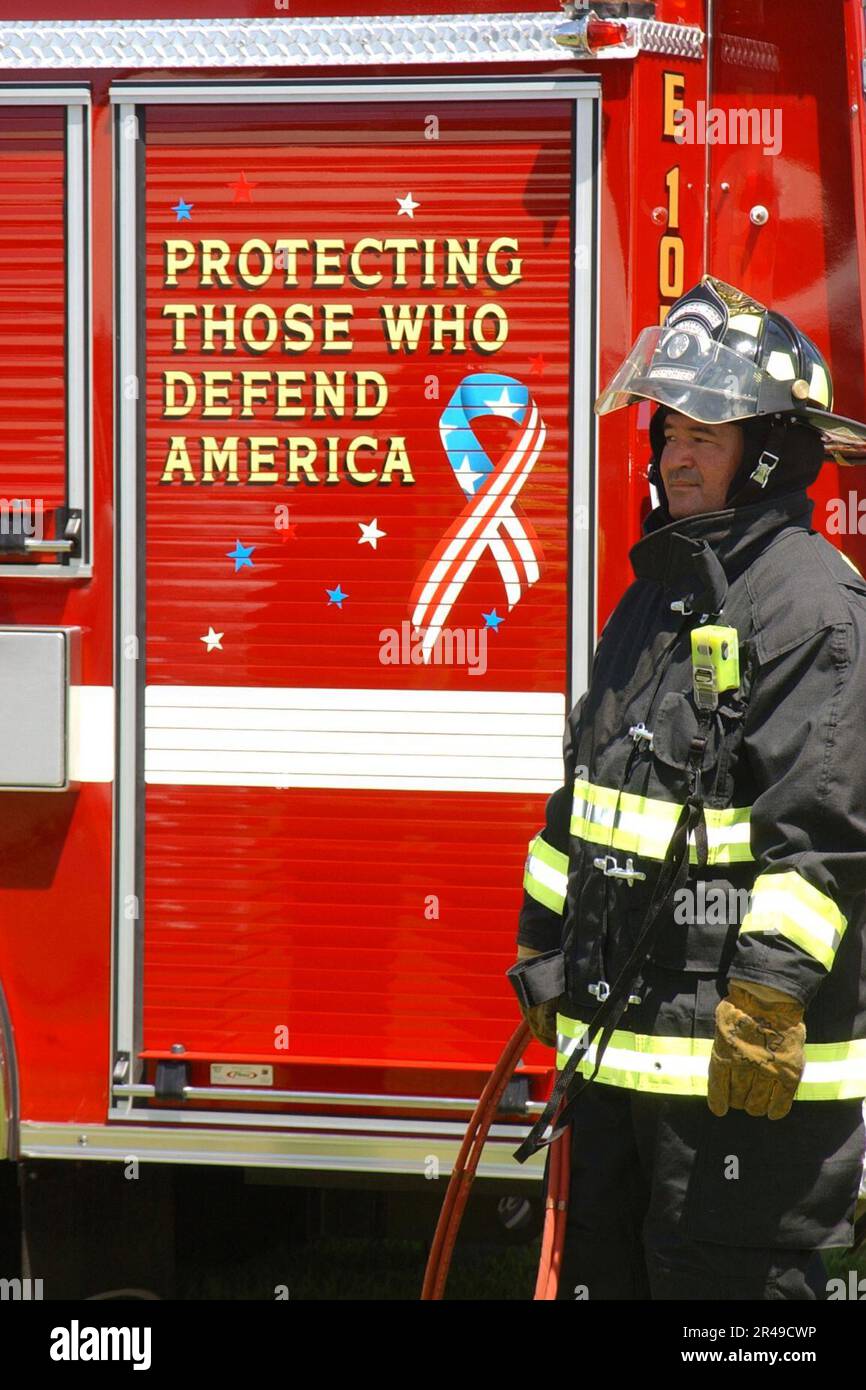 US Navy A member of the Oahu Federal Fire Department stands by one of ...