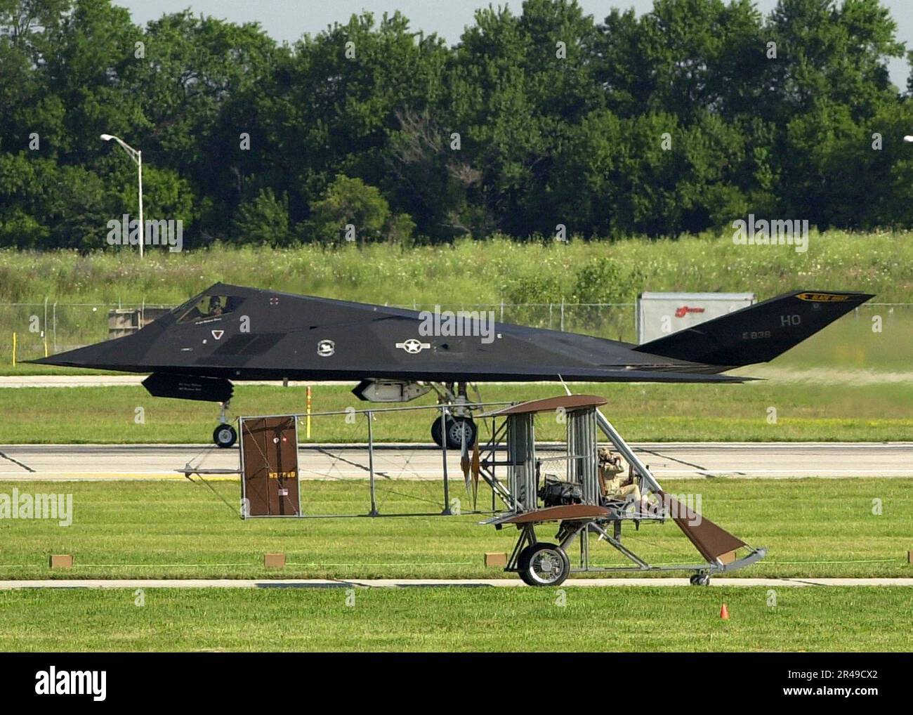 US Navy A Wright B Flyer replica taxis past a United States Air Force F ...