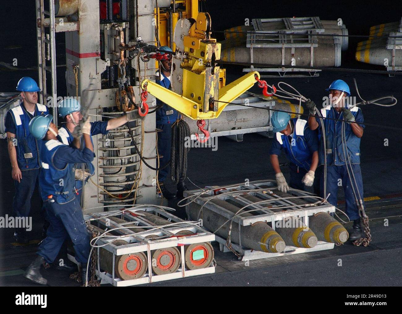 US Navy Deck Department assists in moving artillery storage bins over ...