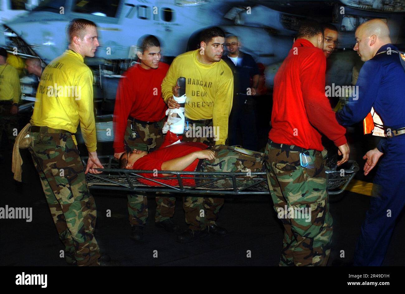 US Navy Stretcher Bearers carry a wounded Sailor through the hangar bay ...