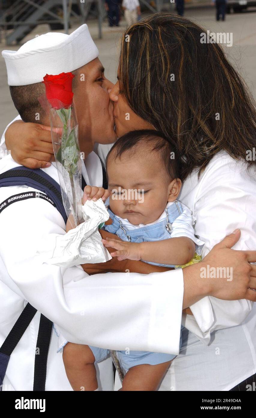 US Navy Petty Officer Florencio Tolley is greeted by his wife and ...
