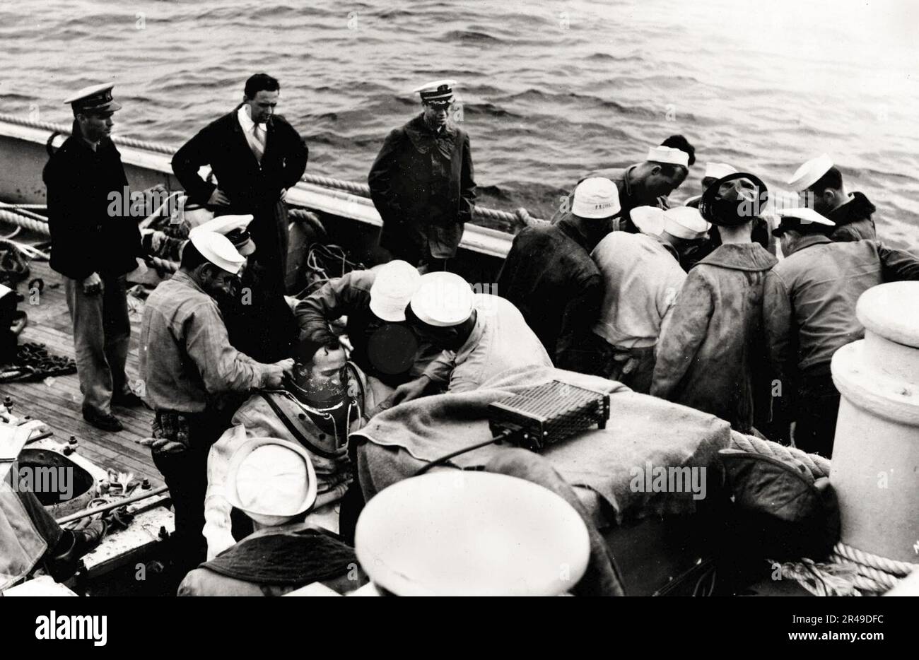 US Navy Cdr. Charles 'Swede' Momsen stands next to the rail (third from ...