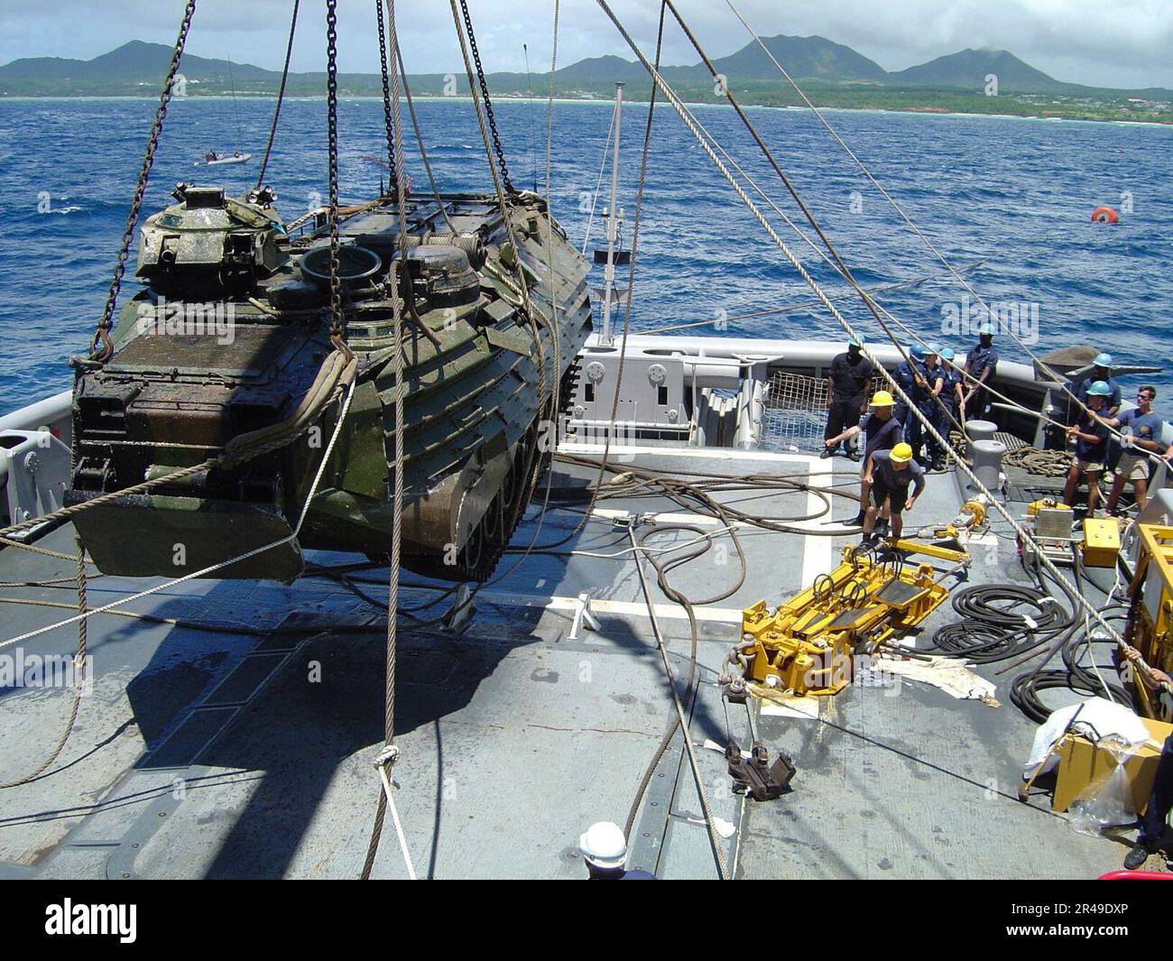 US Navy Crewmembers of USS Safeguard (ARS 50) maneuver a 26-ton ...