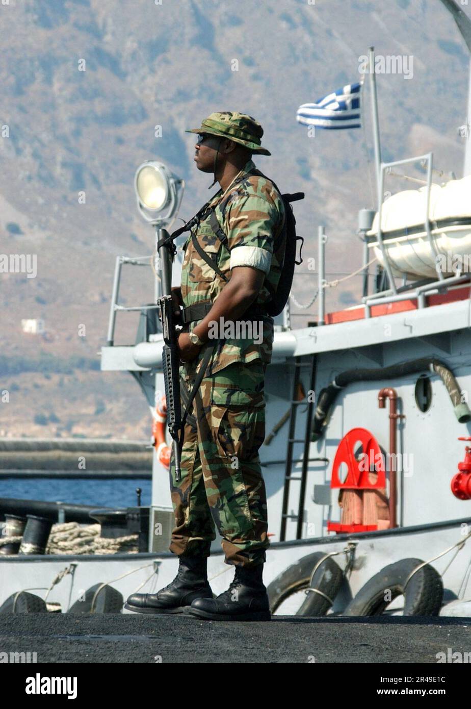 US Navy A USS Hampton (SSN 767) crewmember stands a security watch as ...