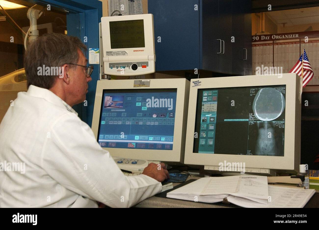 US Navy A civilian technician follows the progress of a CT Scan at the ...