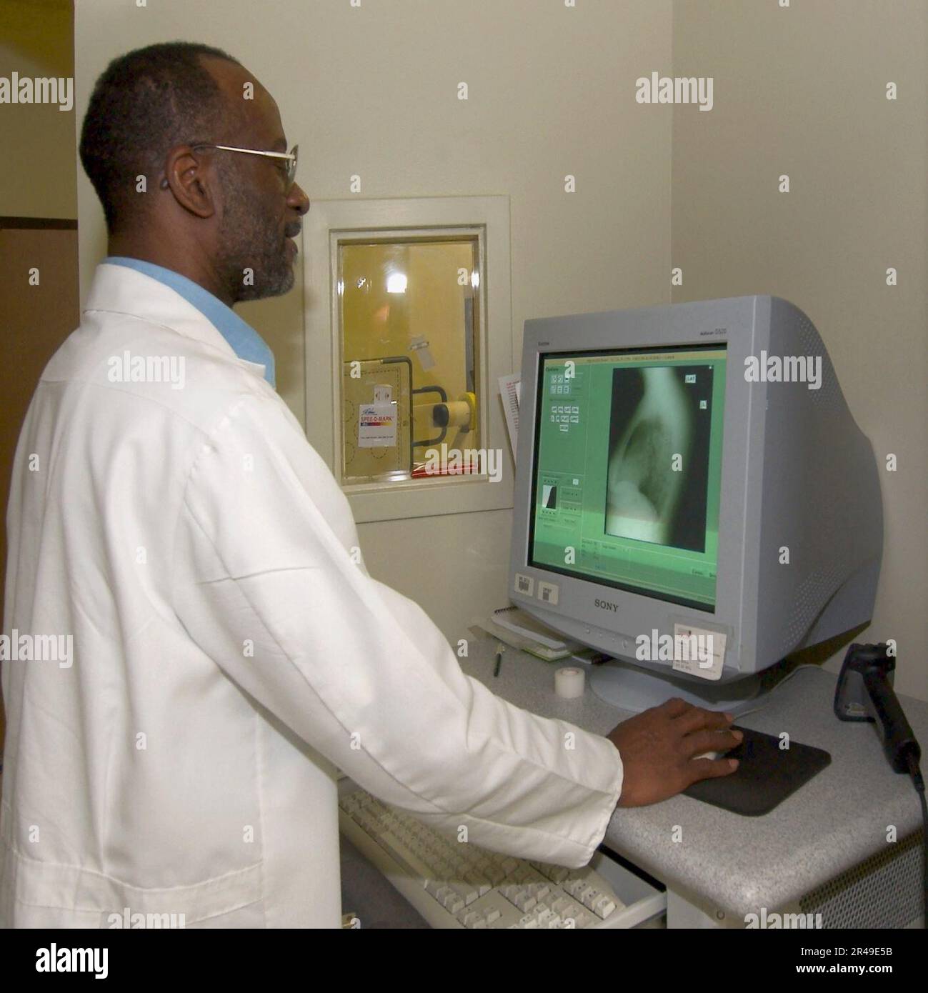US Navy Lead x-ray technologist, James Crisler checks a recent x-ray on ...