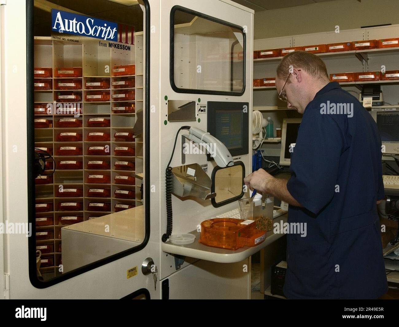 US Navy Hospitalman Randy Connelly, of Breezewood, Penna., refills a ...