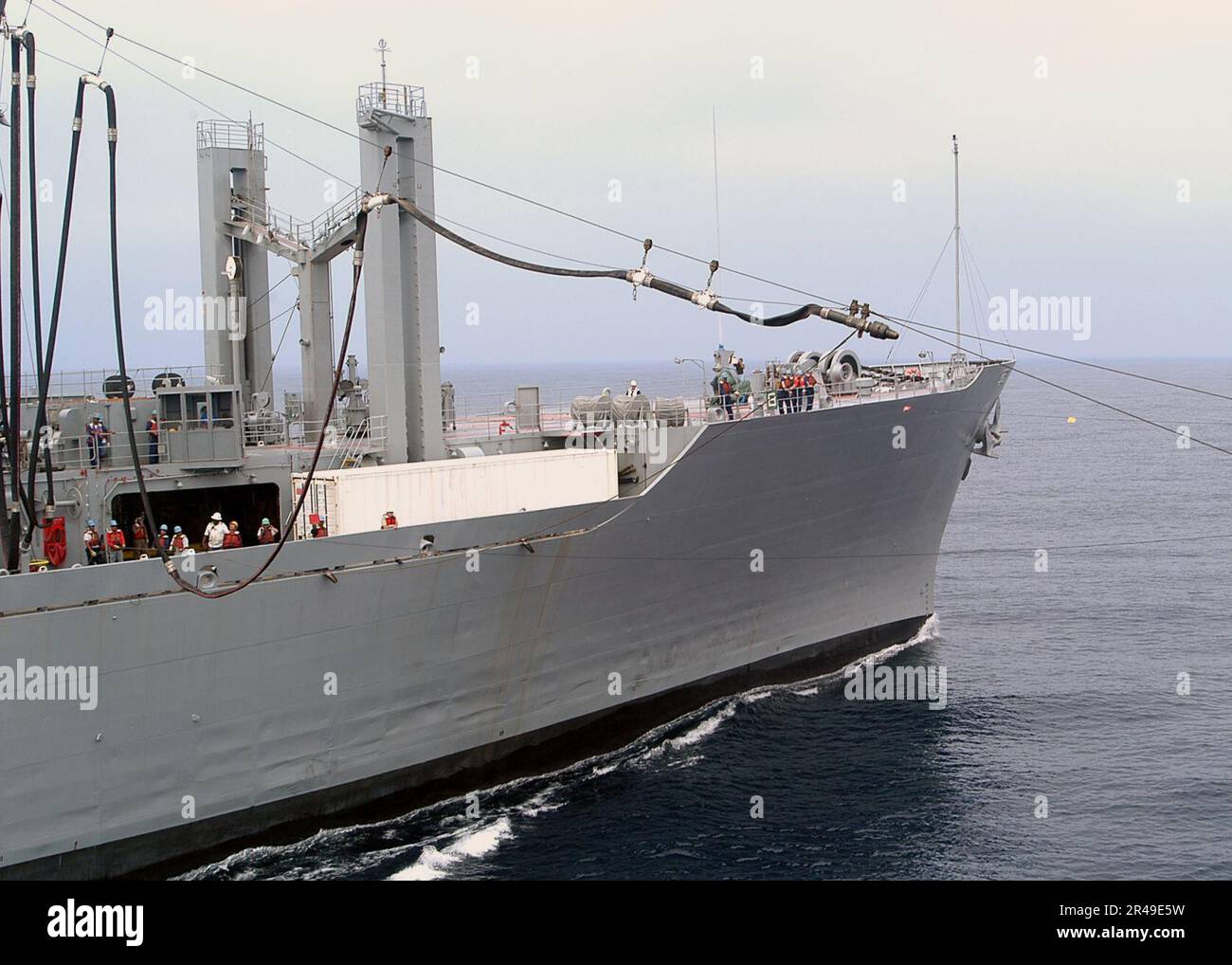 US Navy USNS Niagara Falls (T-AFS-3) sailors direct a replenishment ...