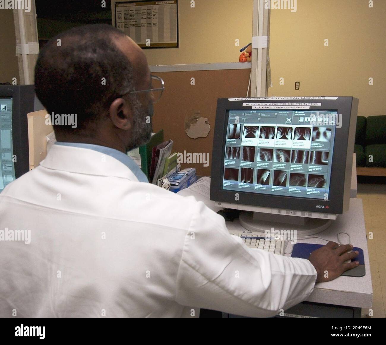 US Navy Lead x-ray technologist, James Crisler checks a group of recent ...