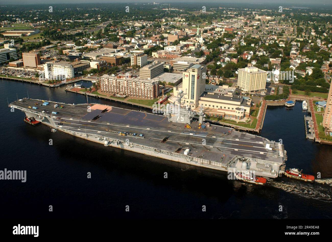 US Navy Tug boats guide USS Harry S. Truman (CVN 75) up the Elizabeth ...