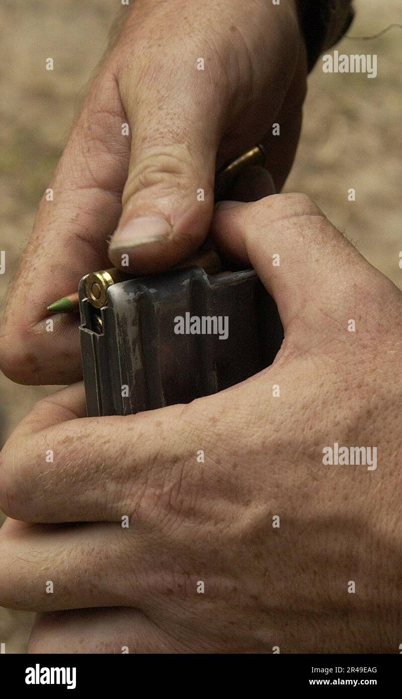 US Navy U.S. Navy SEALs (Sea, Air, and Land) load 5.56mm ammunition ...