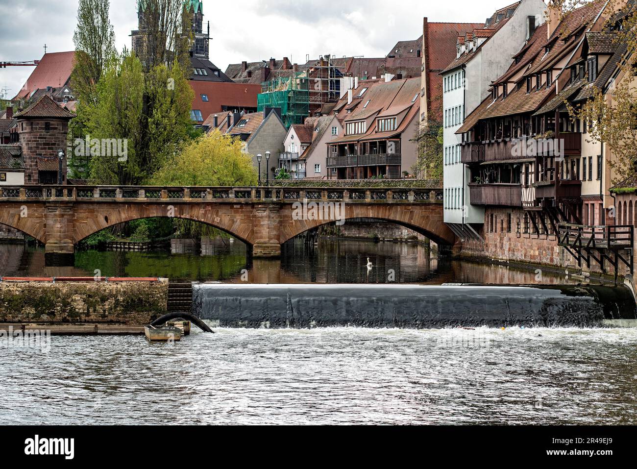 Idyllic scene of a picturesque stone bridge spanning a tranquil stream ...