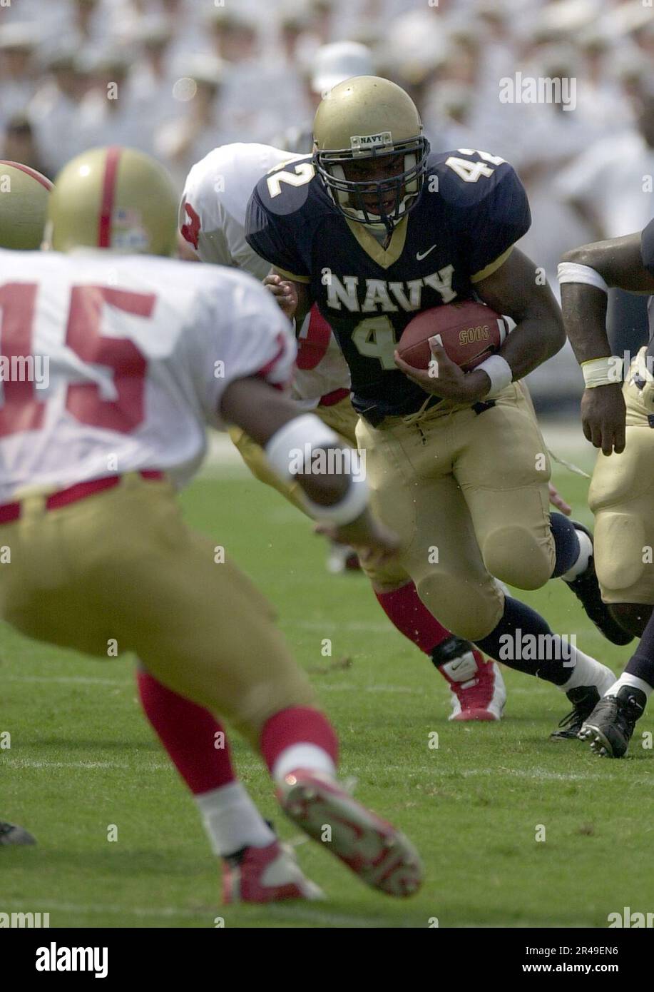 US Navy Navy fullback breaks through a line of Virginia Military ...
