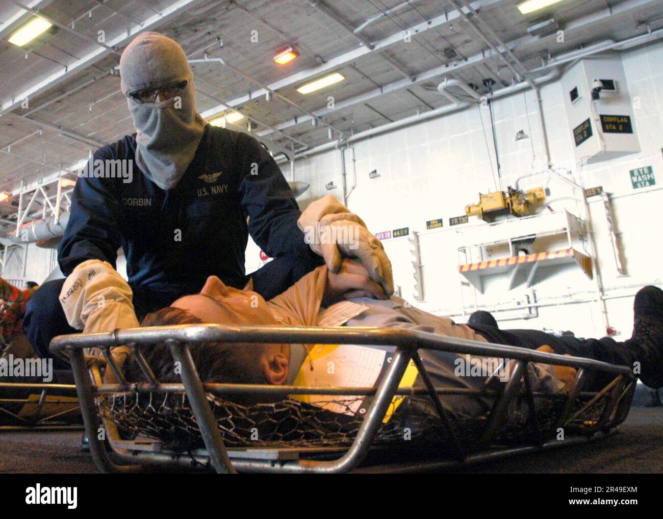 US Navy Hospital Corpsman 1st Class tends to an injured Sailor during a ...