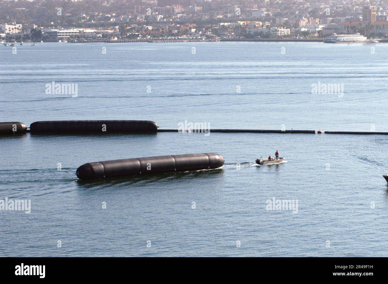 US Navy Workers install new eight-foot floating security barriers Stock ...