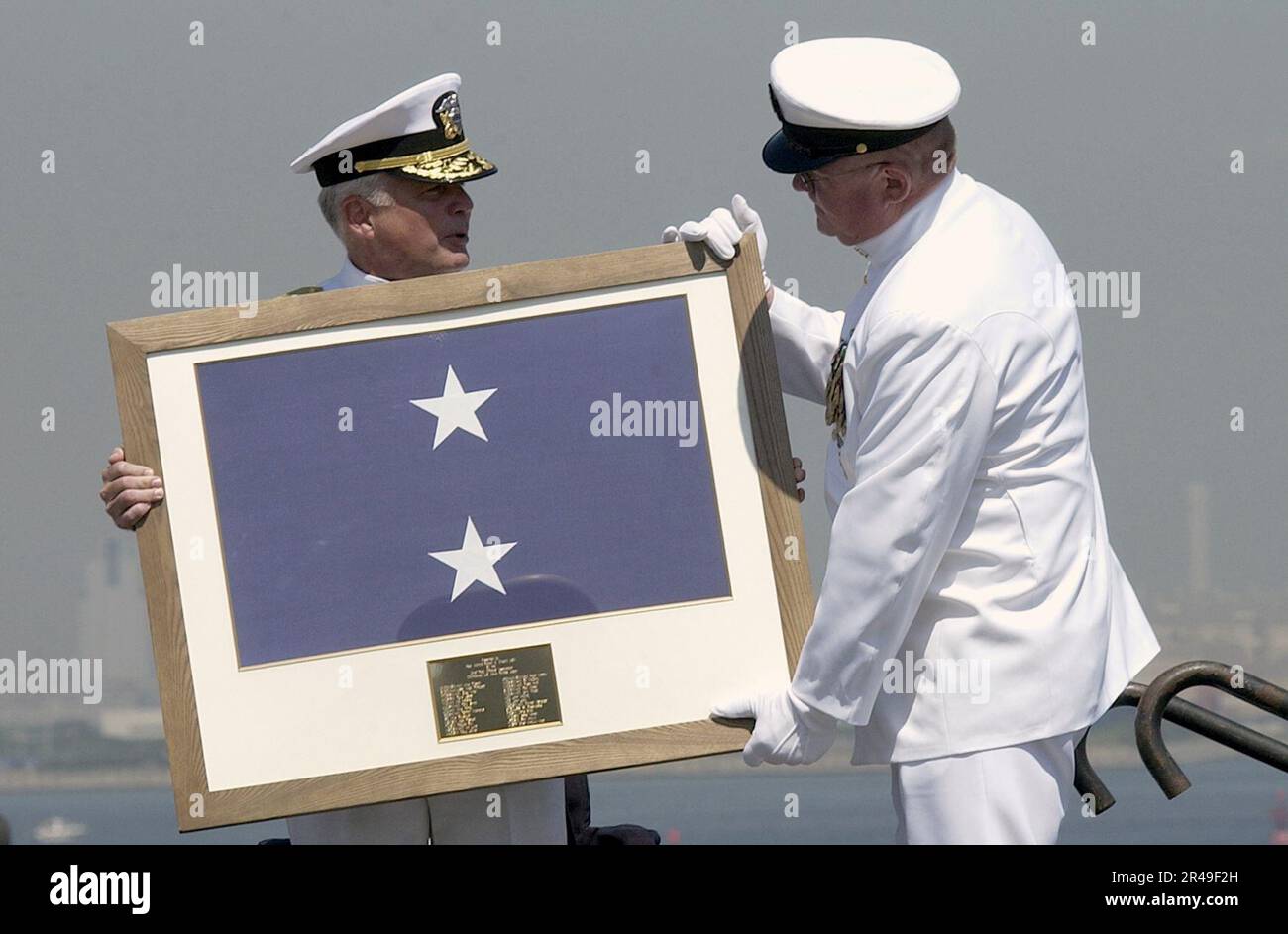US Navy Rear Admiral Robert C. Chaplin receives his flag from Commander ...